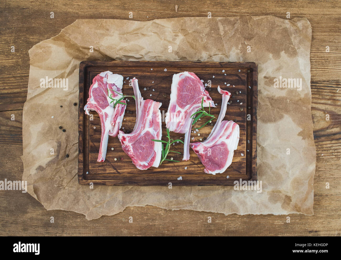 Raw lamb chops. Rack of Lamb with rosemary and spices on rustic ...