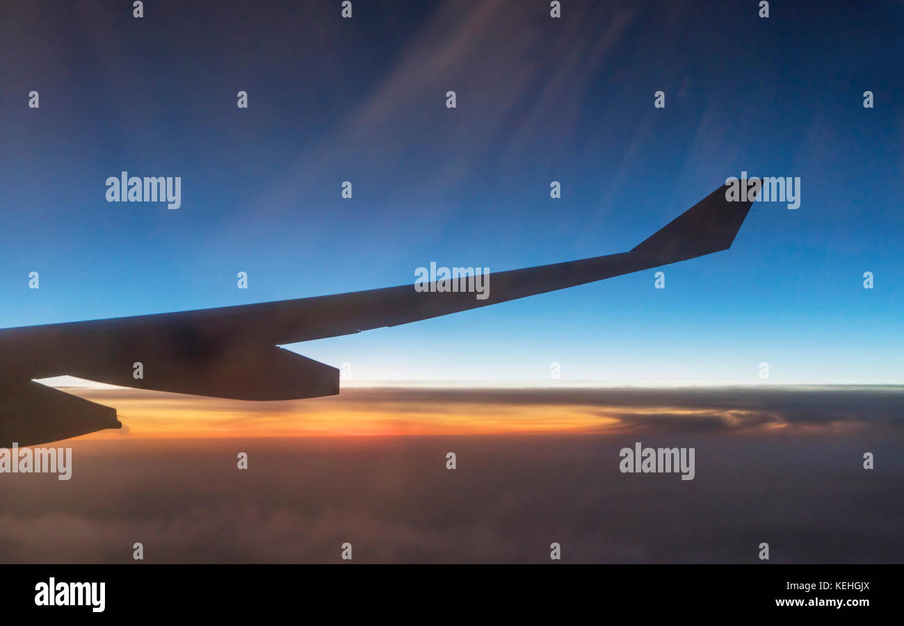 Wing of airplane flying in sky Stock Photo - Alamy