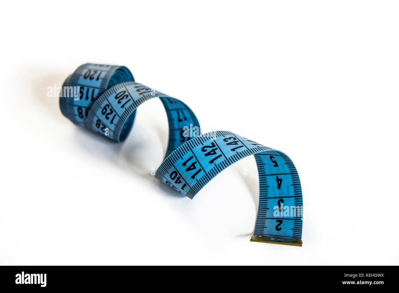 Coiled blue measure tape. Isolated on white Stock Photo - Alamy
