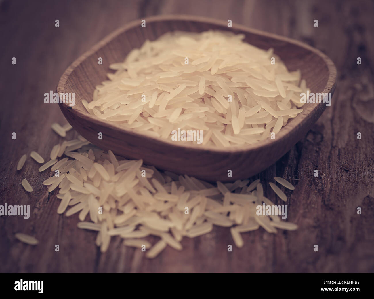 Basmati rice in a bowl on wooden surface Stock Photo - Alamy