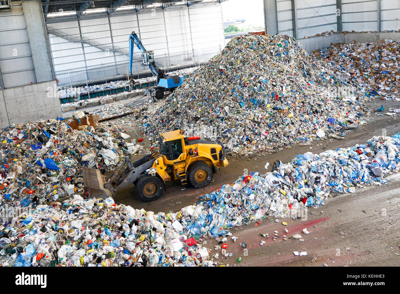 Bulldozer pushing pile of trash Stock Photo - Alamy