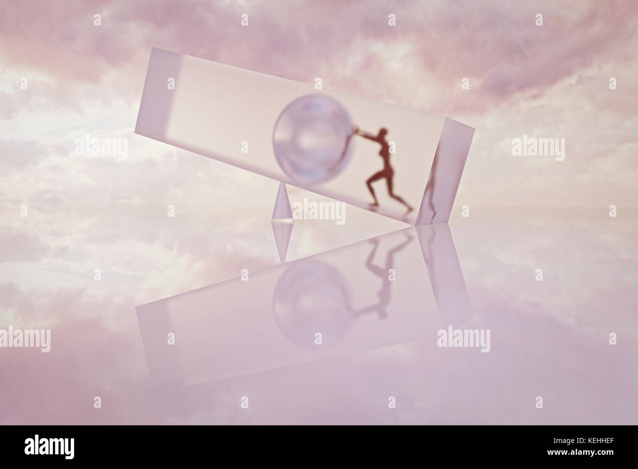 Silhouette of a woman pushing sphere on fulcrum Stock Photo - Alamy