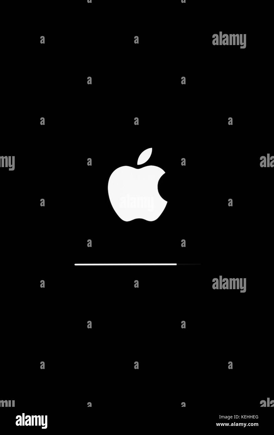 A close-up photo of Apple iPad Air start screen with Apple icon, and ...