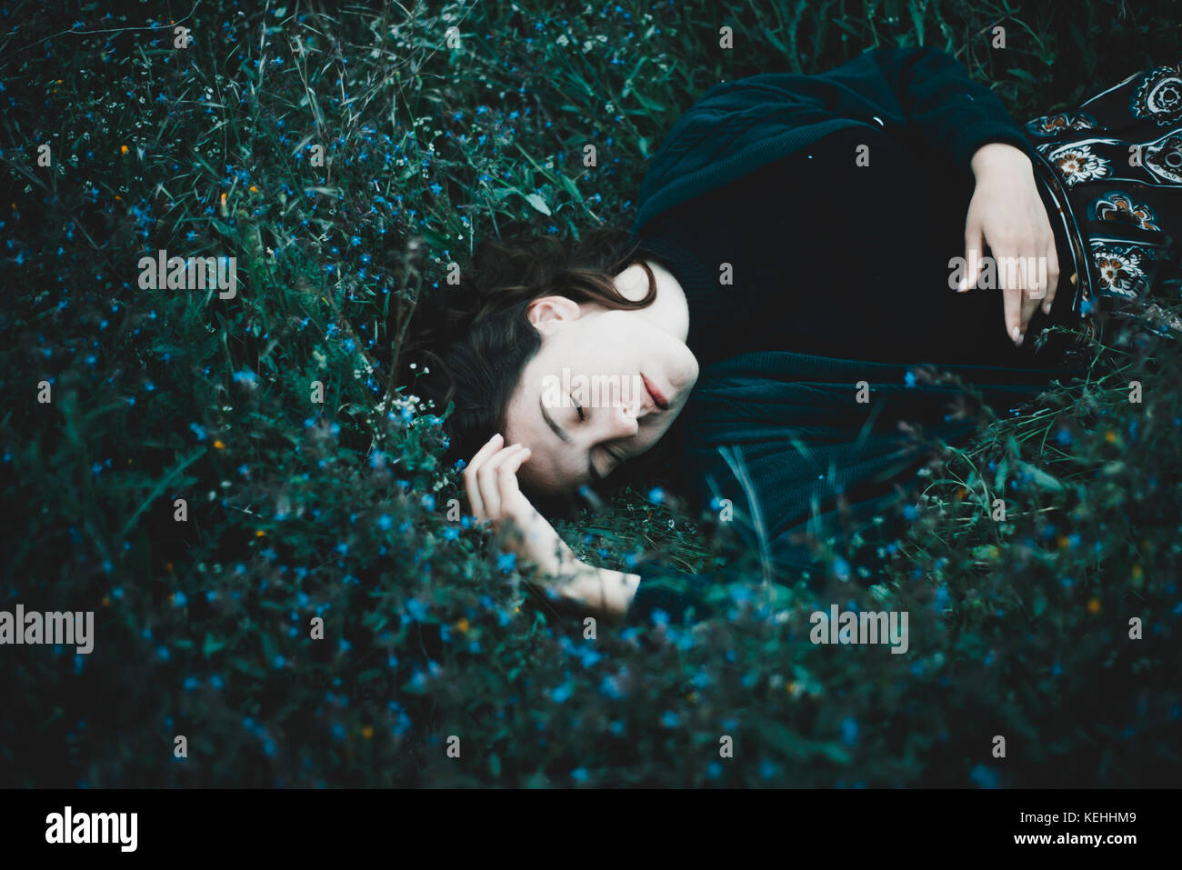 Caucasian woman laying in field of wildflowers Stock Photo - Alamy