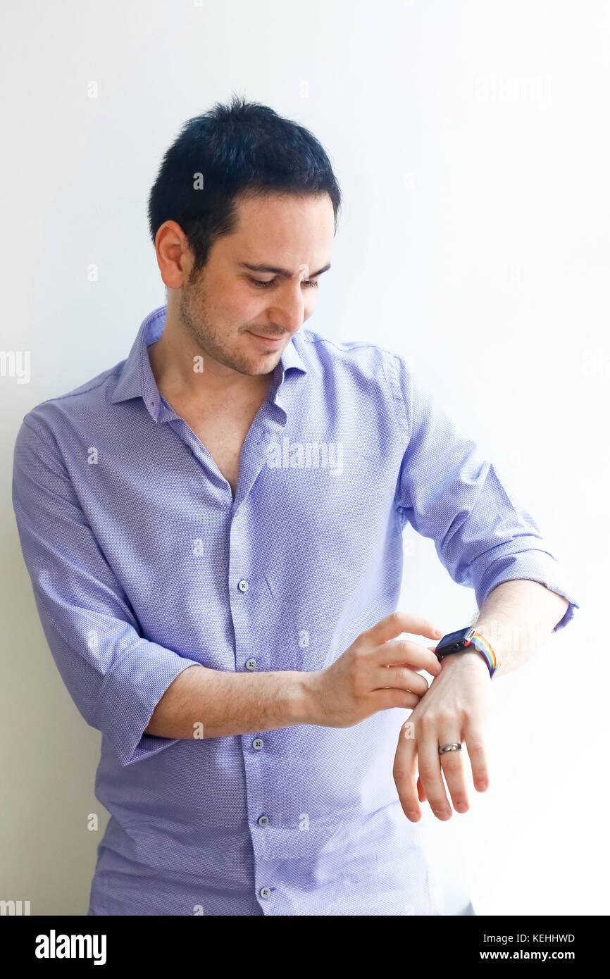 Caucasian man checking the time on wristwatch Stock Photo - Alamy