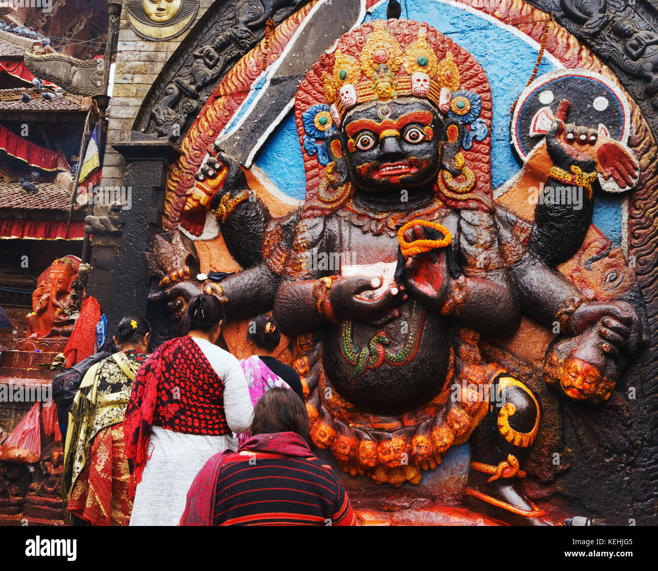 Hindu women bringing offerings at the monument of Black Bhairab, a ...