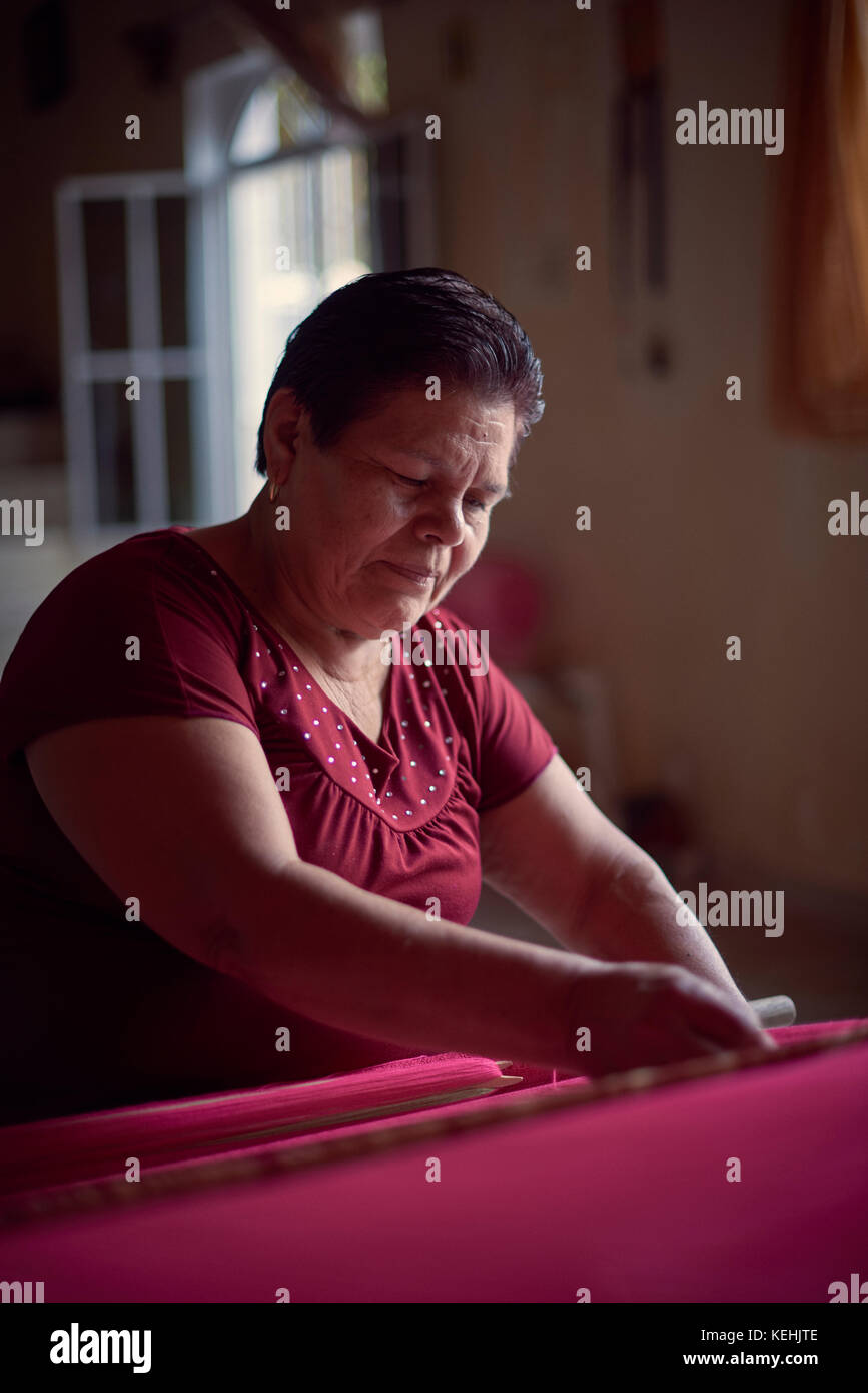 Hispanic woman weaving fabric on loom Stock Photo - Alamy