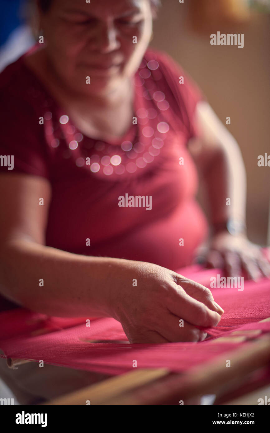 Hispanic woman weaving fabric on loom Stock Photo - Alamy