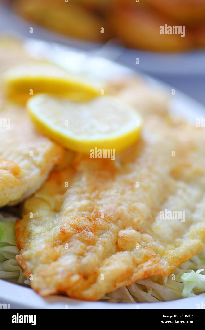 Closeup of fried catfish with lemon slices Stock Photo - Alamy
