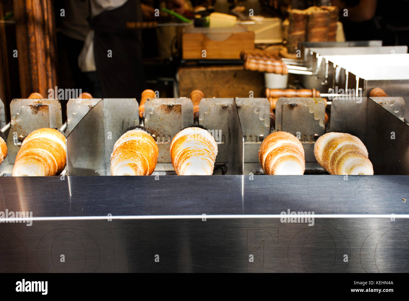 Czechia people making and grilling bread prague style called Trdelnik ...