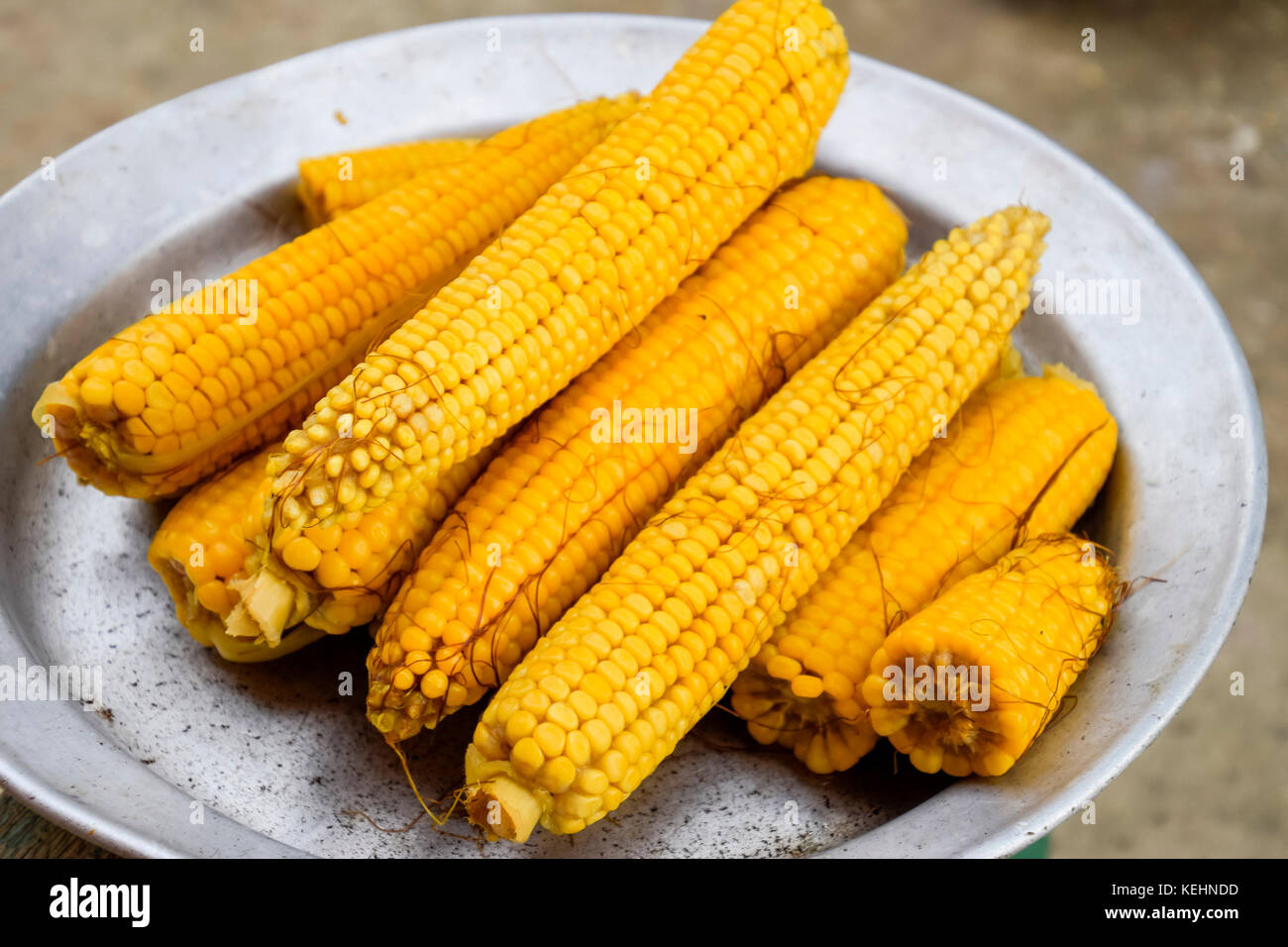 Boiled corn on an aluminum tray. Yellow boiled young corn, useful and ...