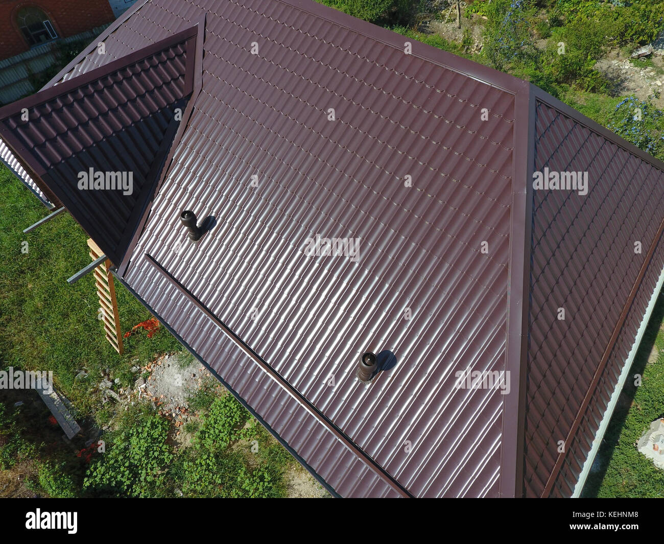 The roof of corrugated sheet. Roofing of metal profile wavy shape. A ...