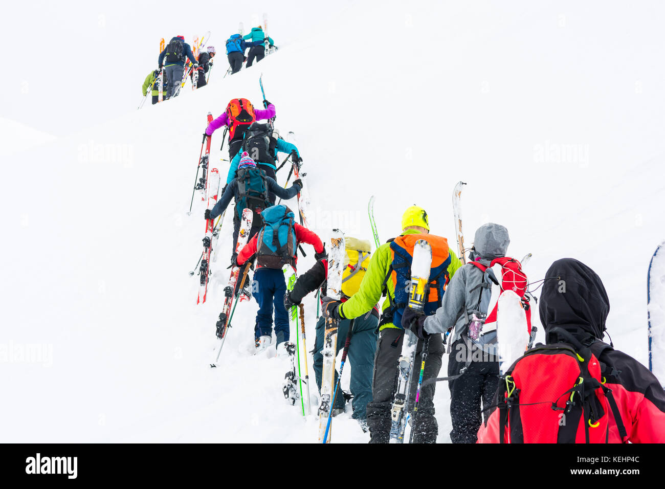 Group of cross-country skiers ascending a steep slope Stock Photo - Alamy