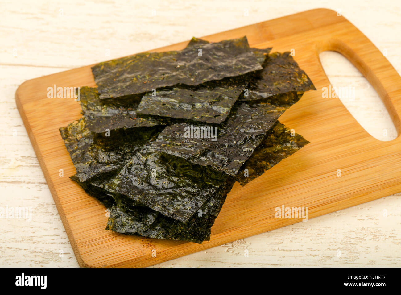 Crispy Nori sheets chips over wooden background Stock Photo - Alamy