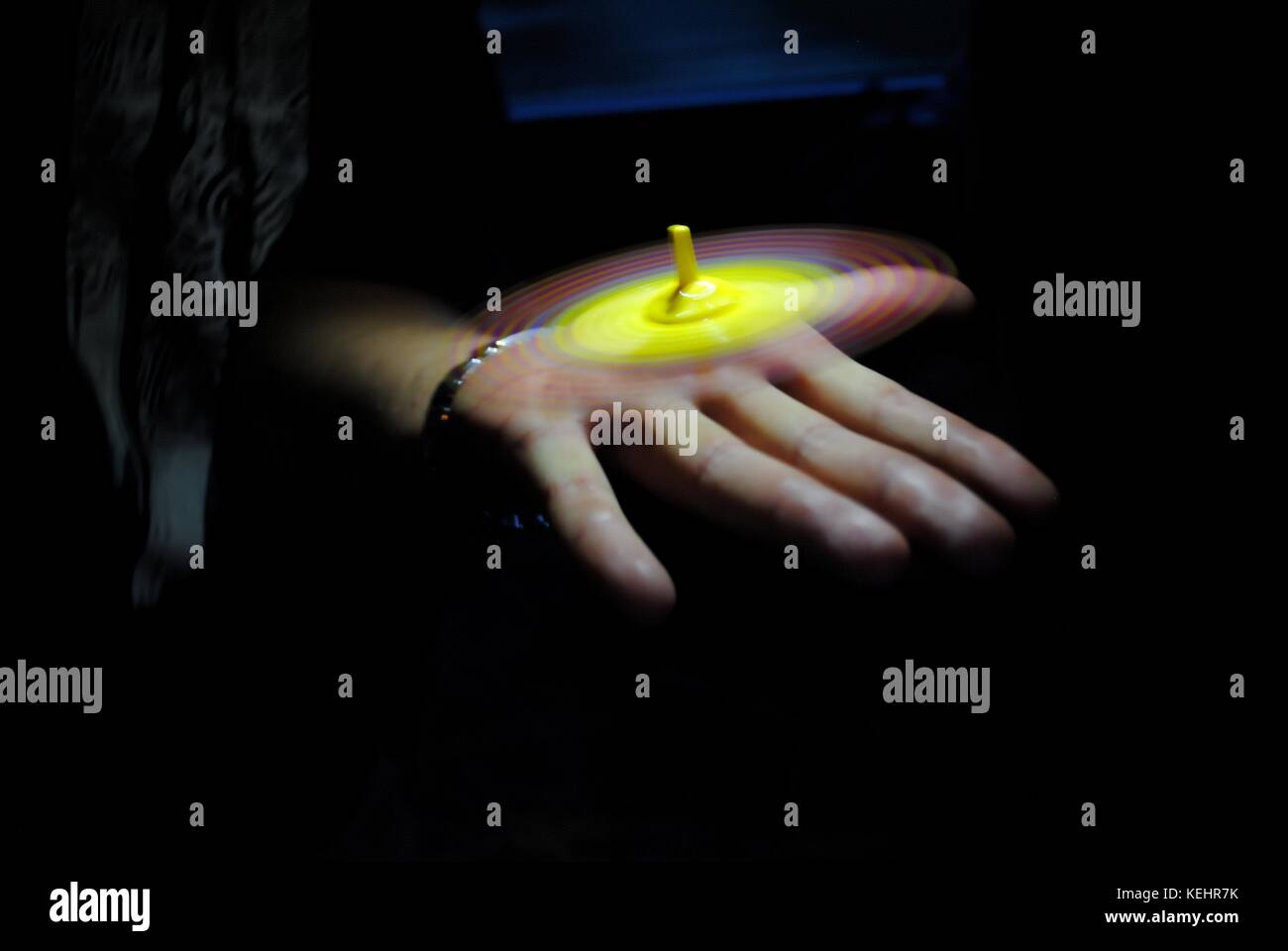 Peg top on hand Stock Photo - Alamy