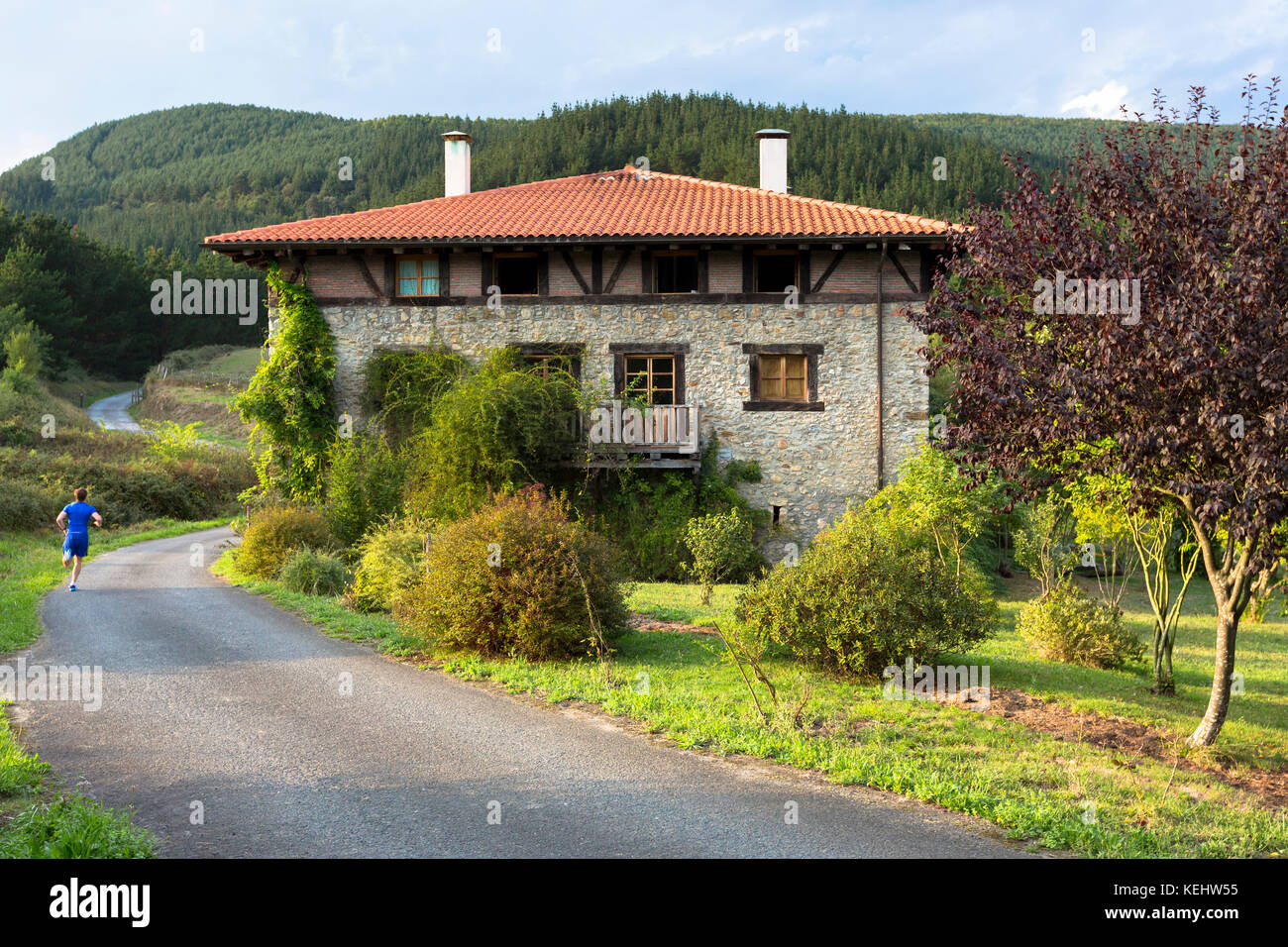 Runner passes Casa Rural Ametzola hotel traditional Basque architecture ...