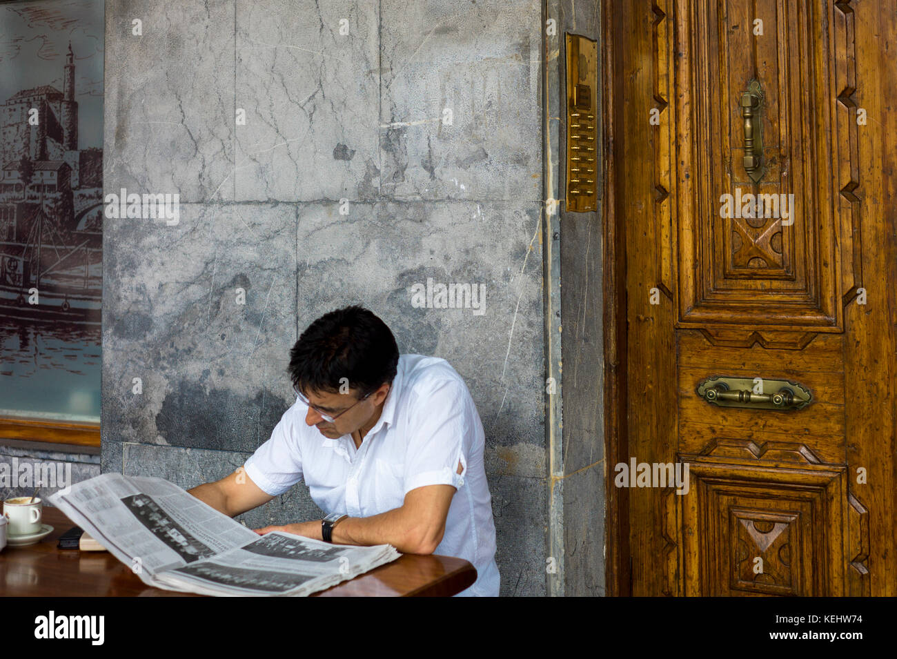 Man reading Spanish newspaper in bar cafe in Castro Urdiales in ...