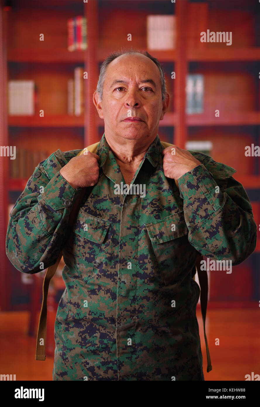 Close up of a serious veteran soldier wearing a military uniform and a ...