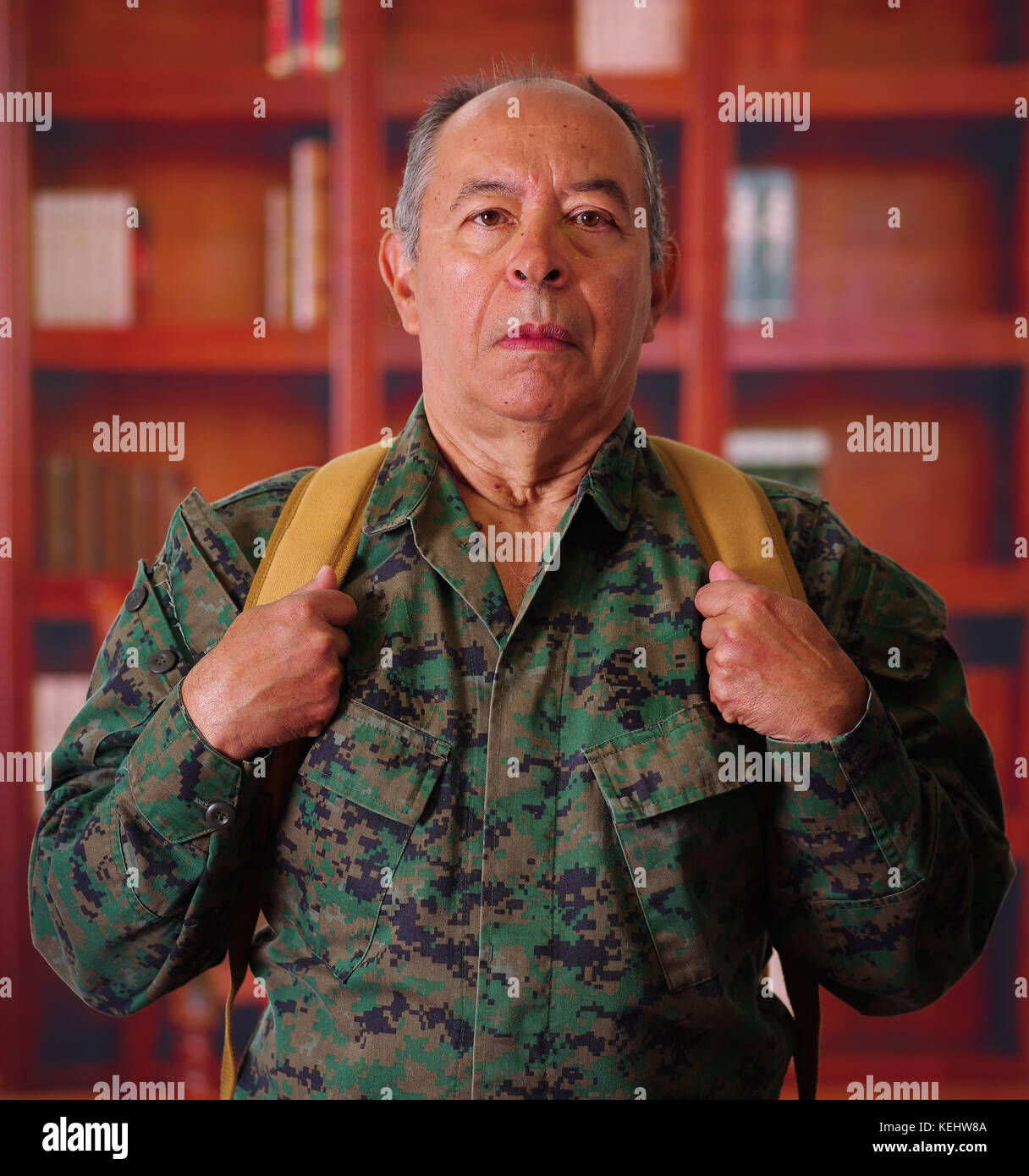 Close up of a serious veteran soldier wearing a military uniform and a ...