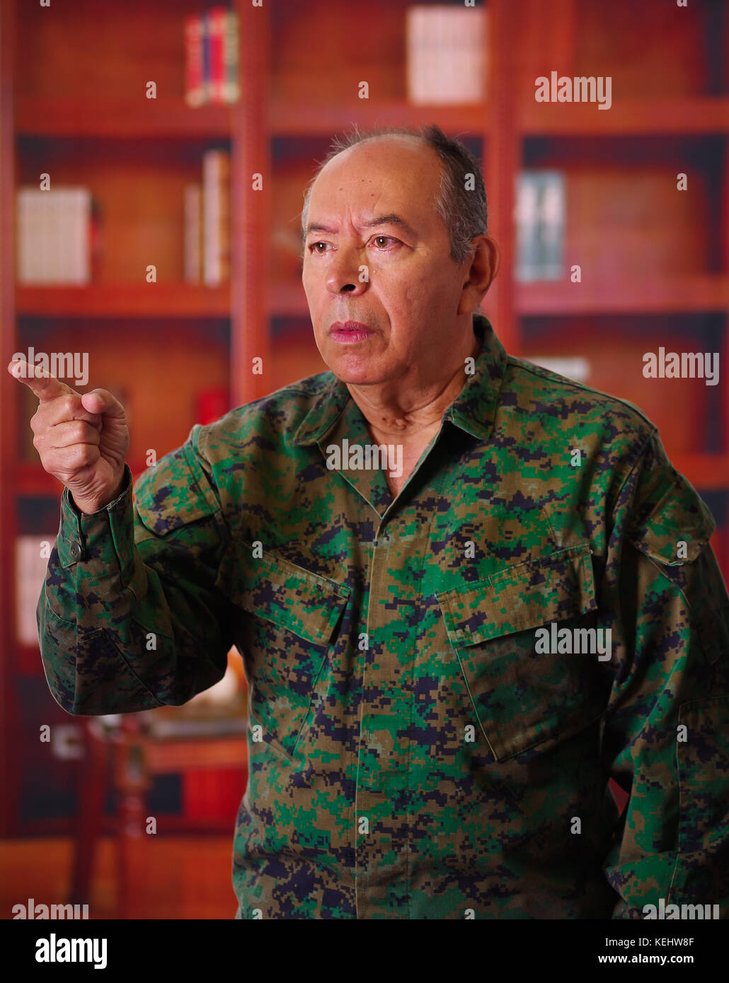 Close up of a serious veteran soldier wearing a military uniform ...
