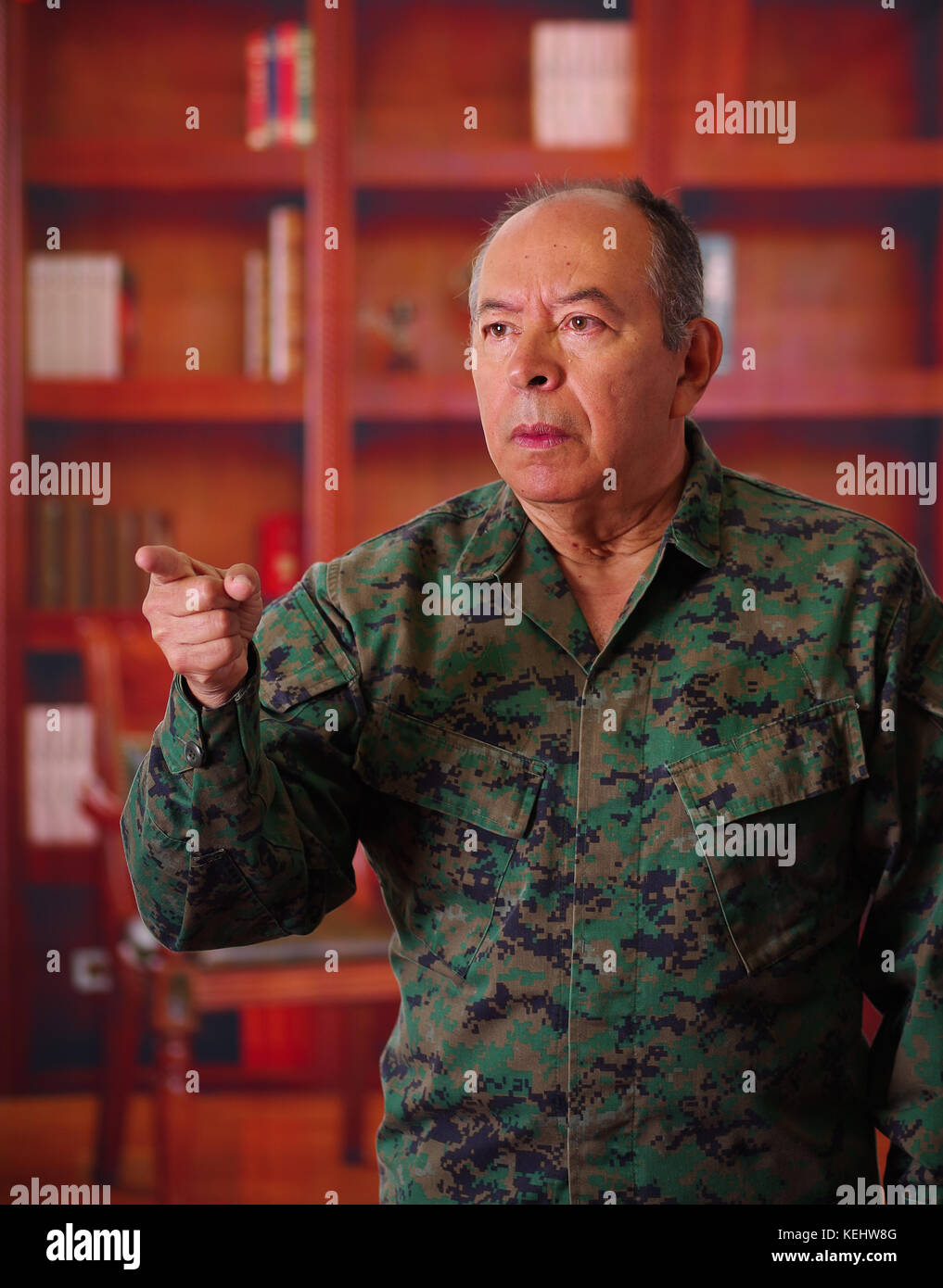 Close up of a serious veteran soldier wearing a military uniform ...
