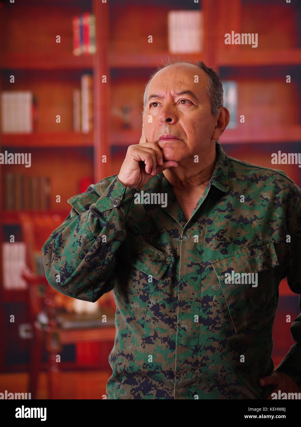Close up of a serious veteran soldier wearing a military uniform ...