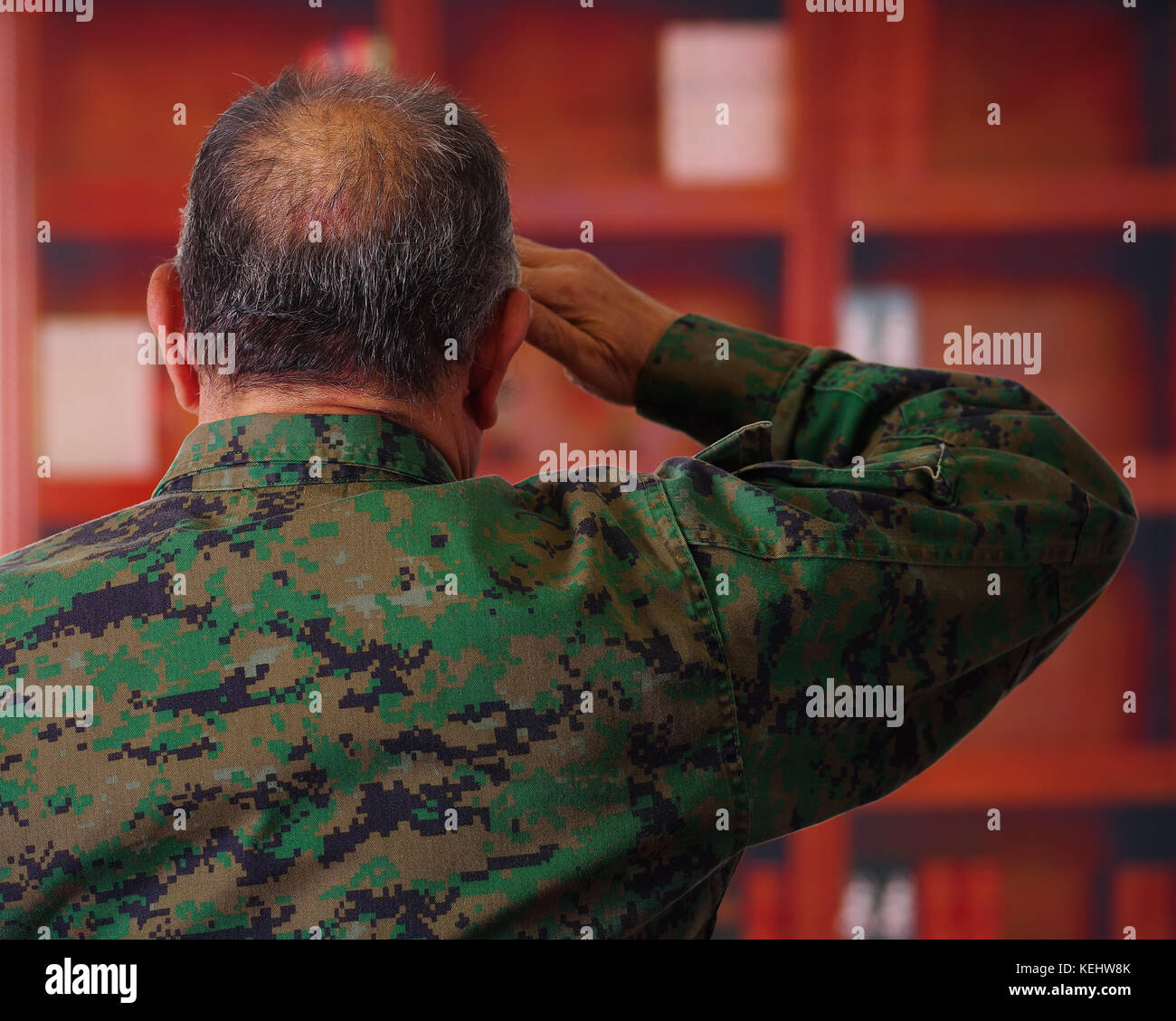 Close up of a serious veteran soldier wearing a military uniform, doing ...