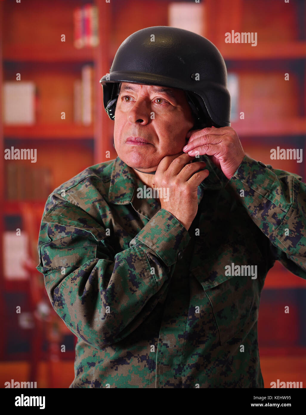 Close up of a serious veteran soldier wearing a helmet and a military ...
