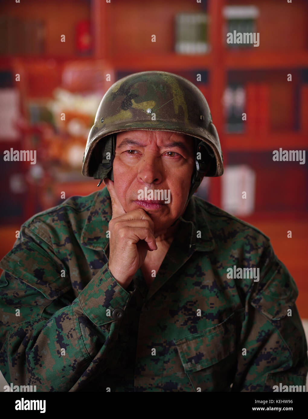 Close up of a serious veteran soldier wearing a helmet and a military ...