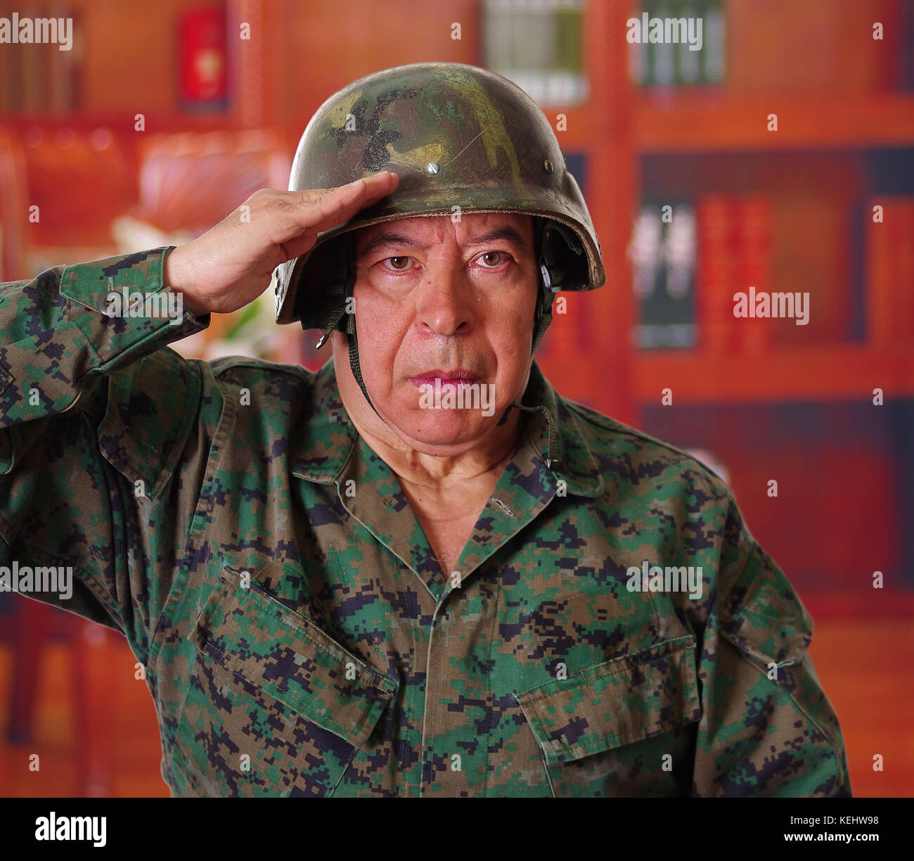 Close up of a serious veteran soldier wearing a helmet and a military ...