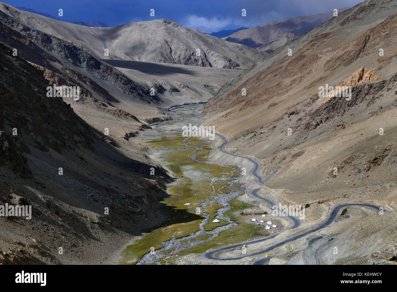 The valley of the river is among the high mountains: steep slopes, a ...