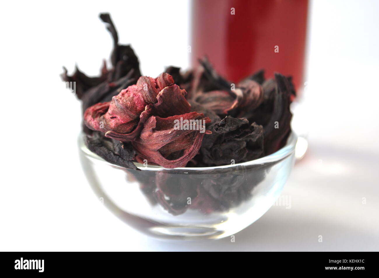 Dried hibiscus petals in a glass bowl and hibiscus infusion tea in the ...