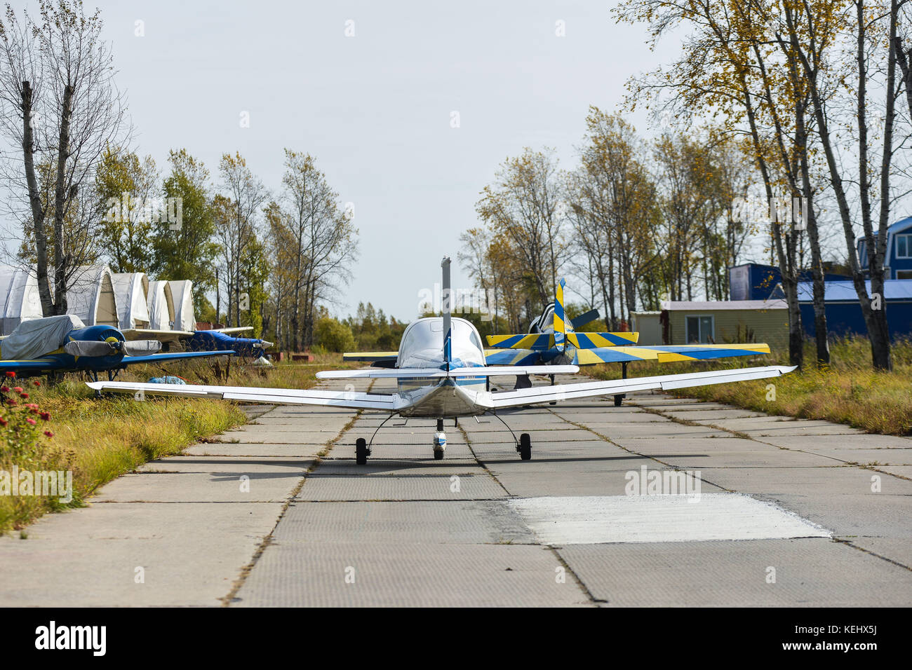 Small plane waiting on the runway . two seater plane is on the runway ...