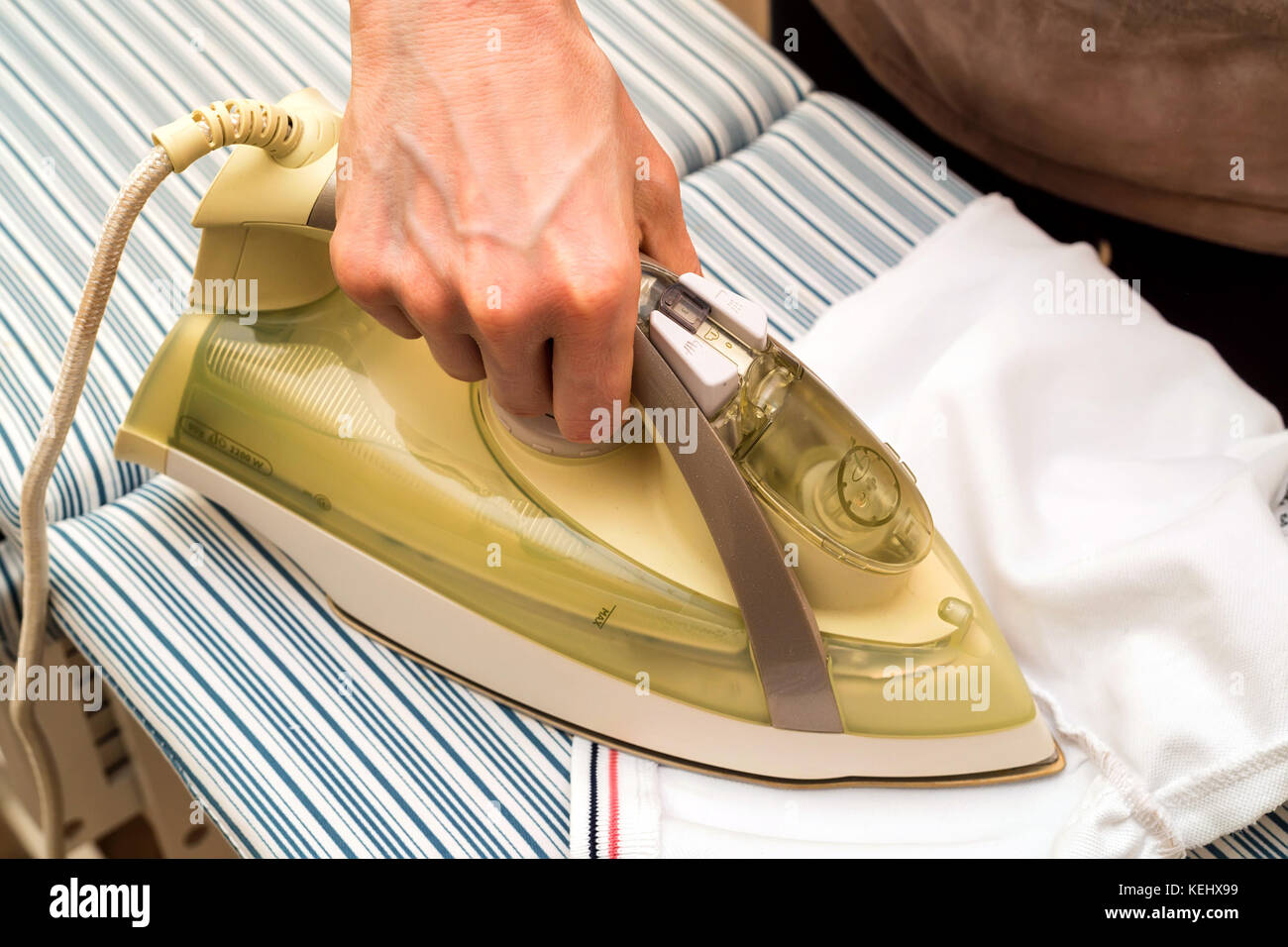 Close-up of female hand ironing Stock Photo - Alamy