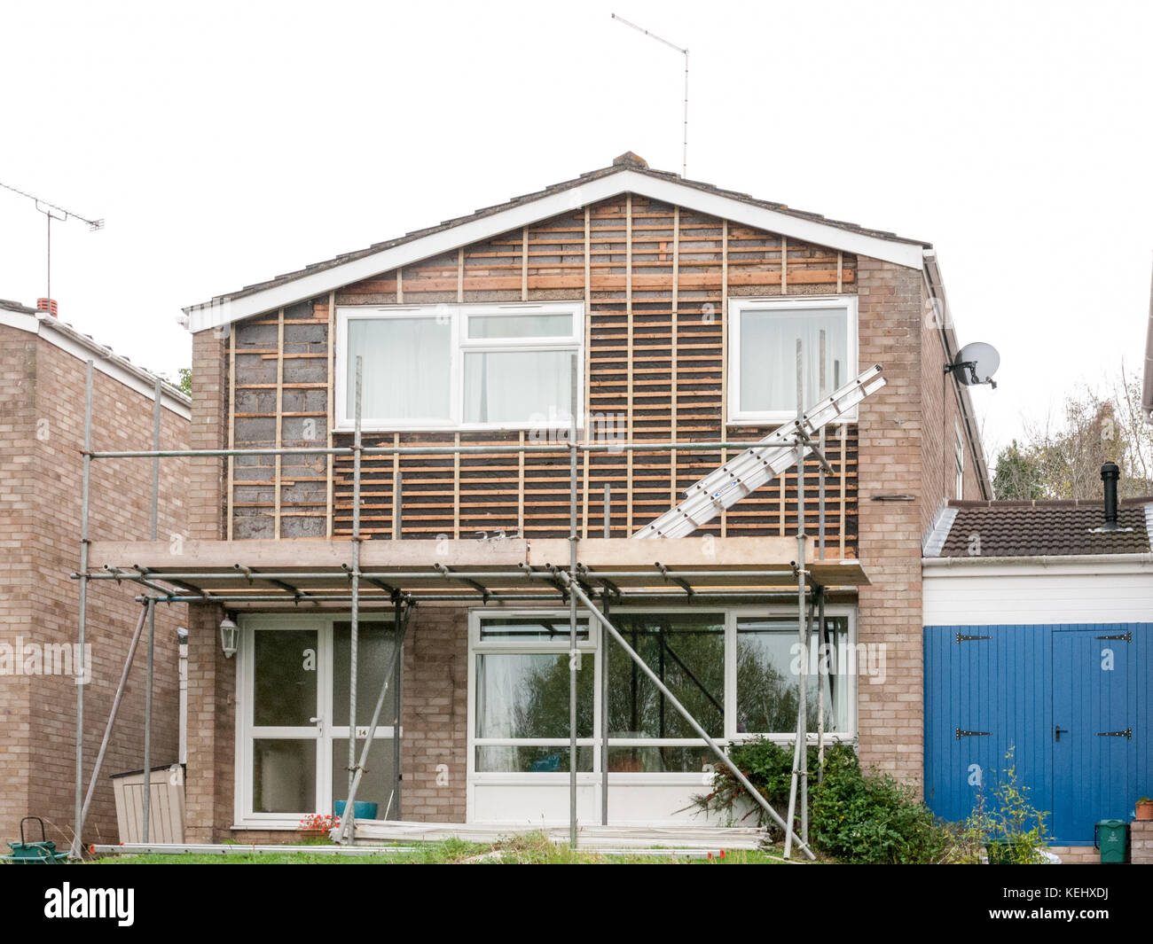 house front with construction scaffolding and panels ; essex; england ...