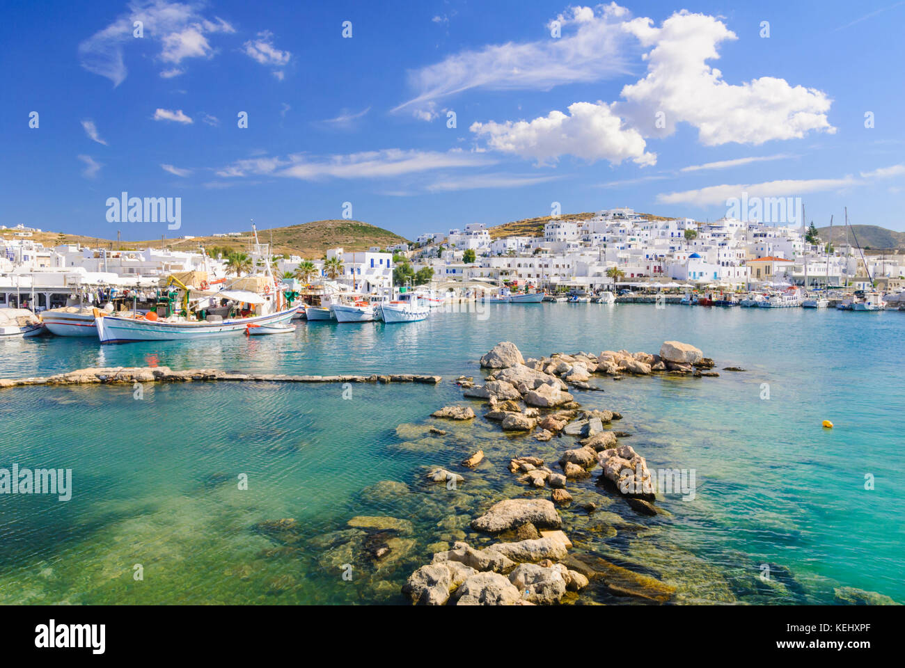 The whitewashed town of Naoussa overlooking the harbour and old ruins ...