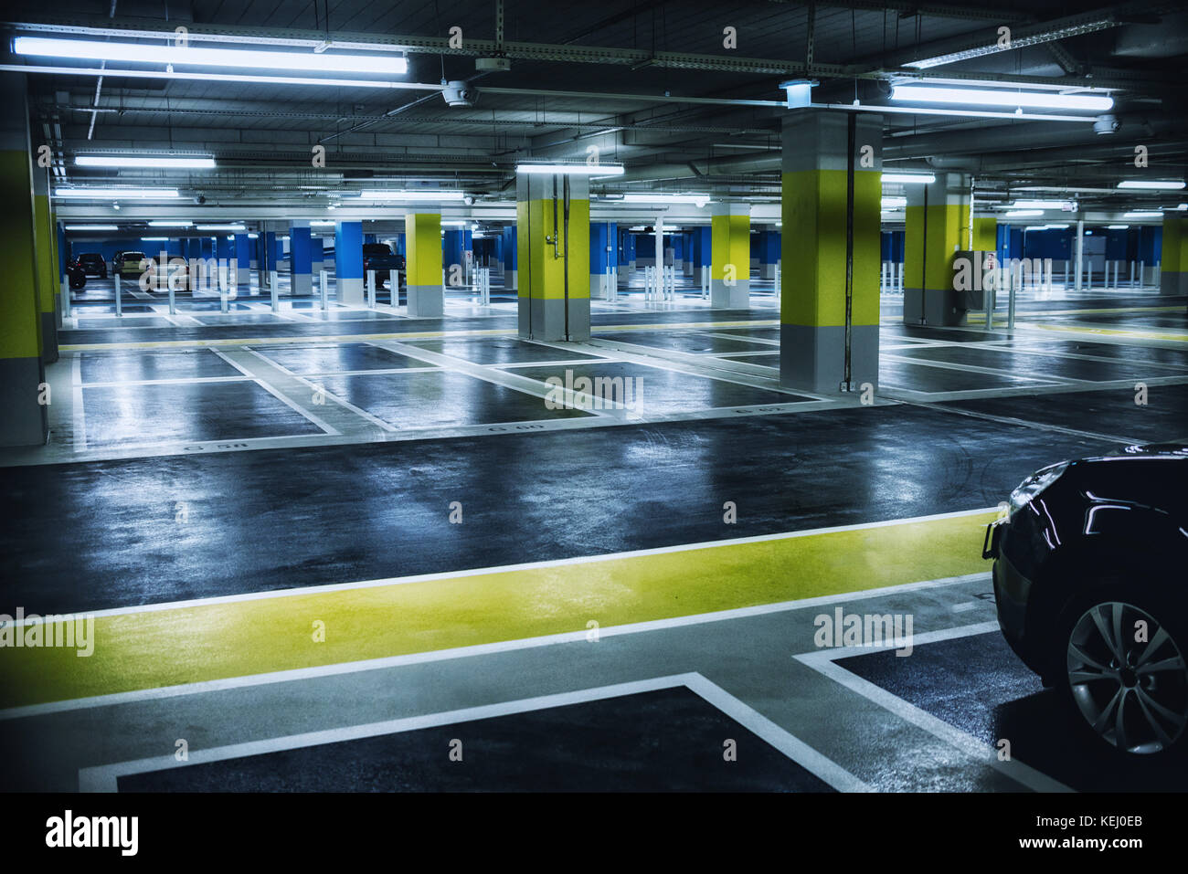 Close up on underground parking with empty slots and car Stock Photo ...