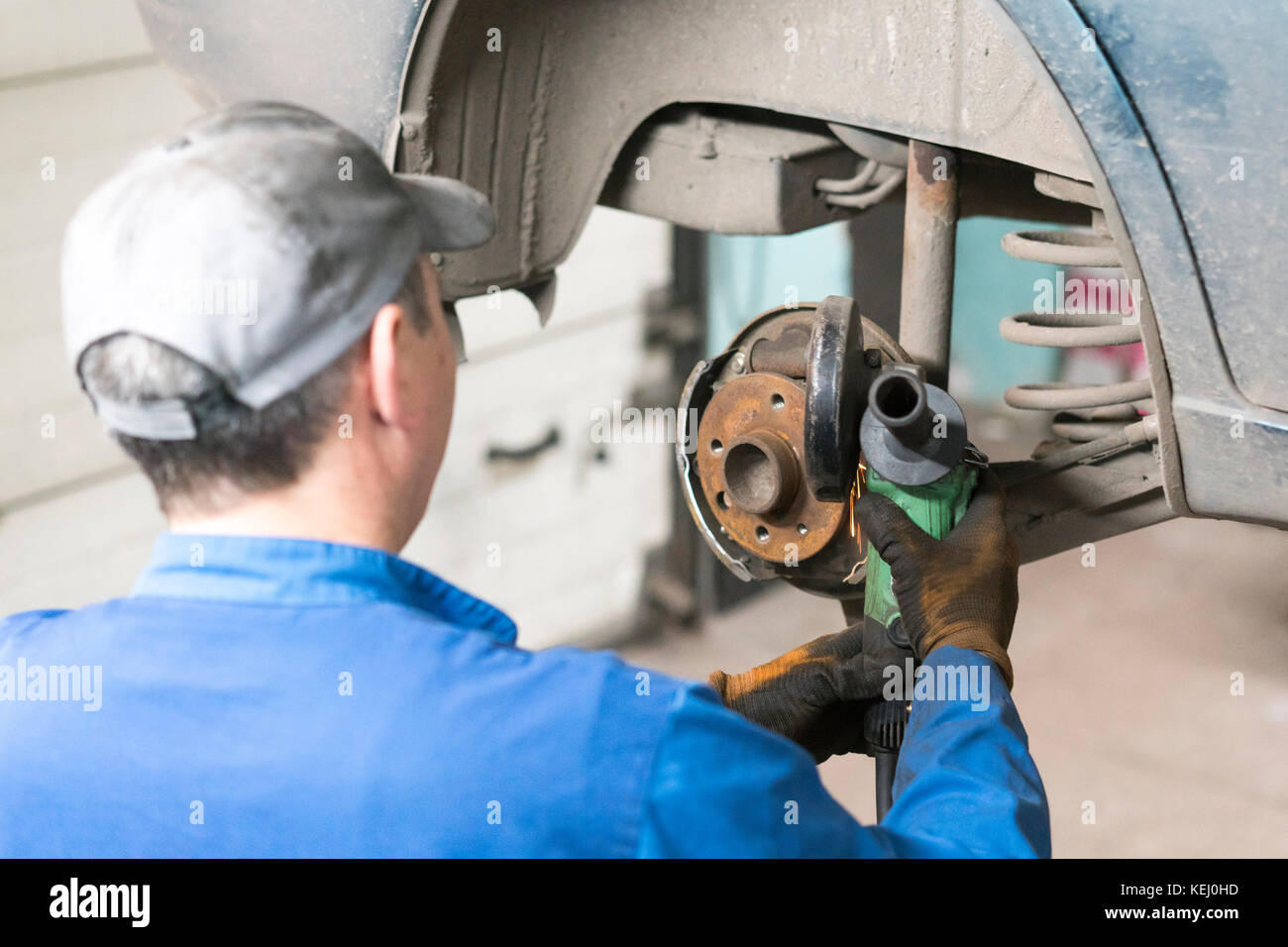 Car mechanic hands replace brakes in garage. Mechanic technician worker ...