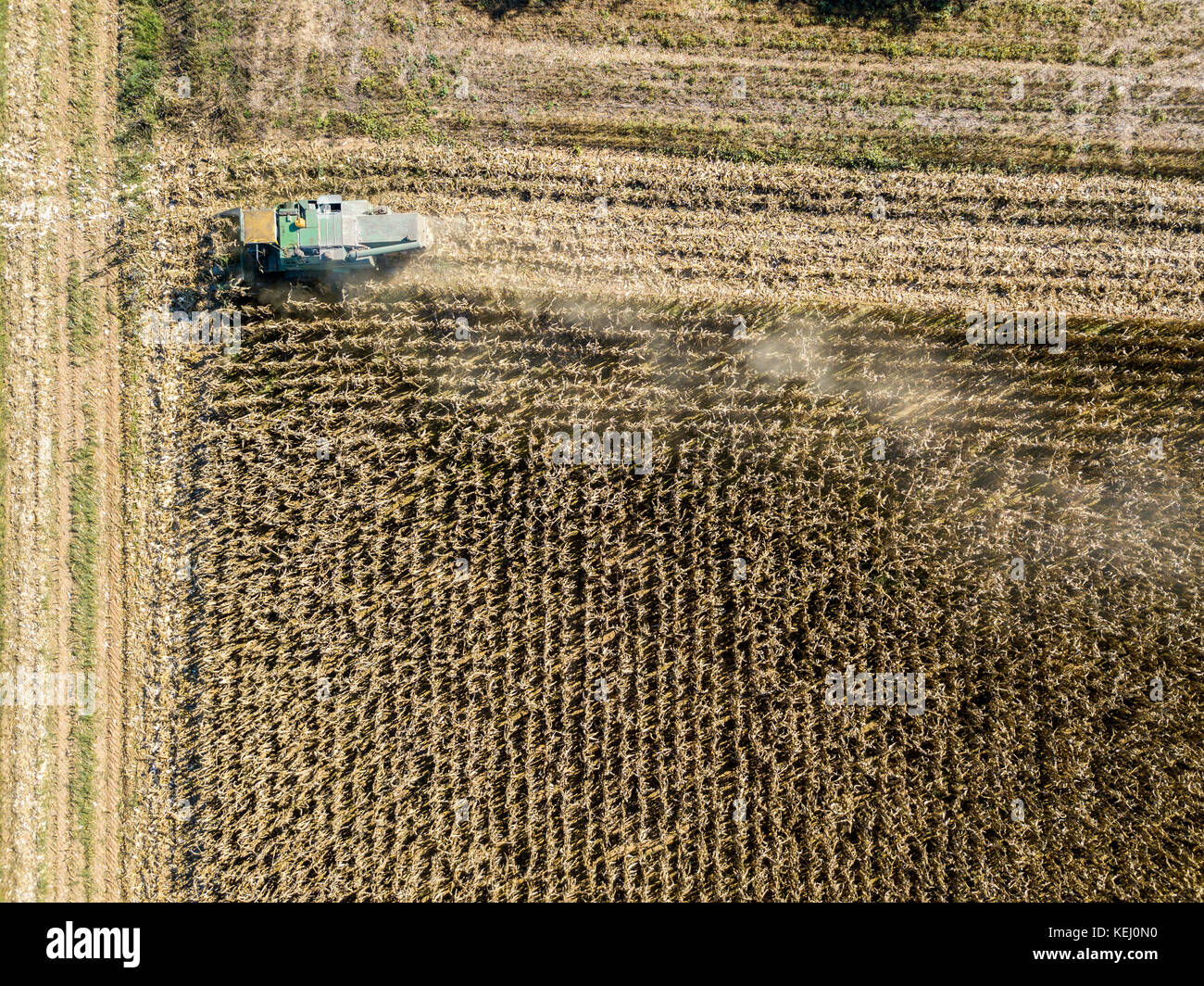 Combine harvester picking seed from fields, aerial view of a field with ...
