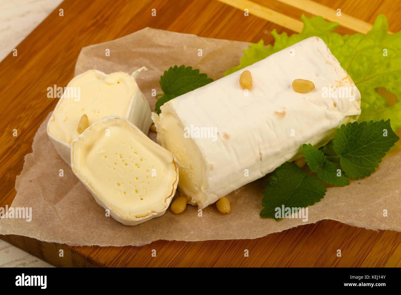 Brie cheese roll with cedar nuts Stock Photo - Alamy