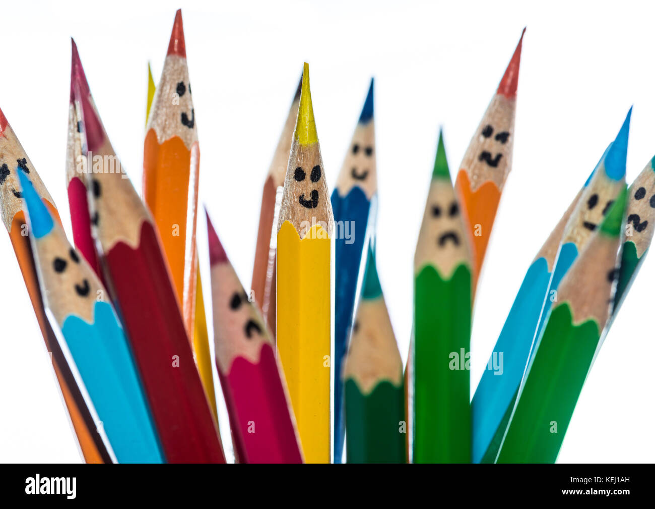 A macro shot of some coloured pencils with faces drawn on them Stock ...