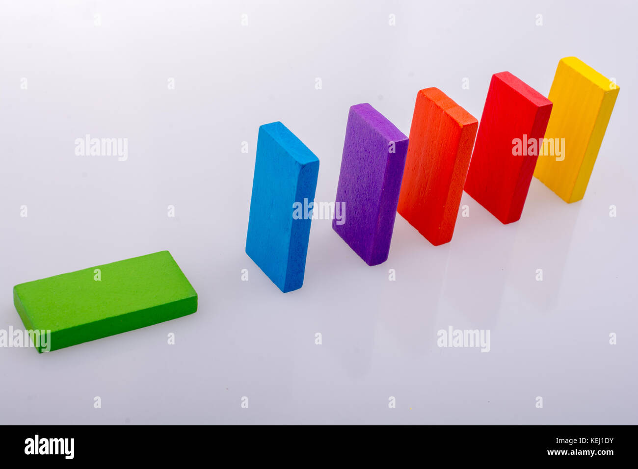 Colorful Domino Blocks in a line on a white background Stock Photo - Alamy