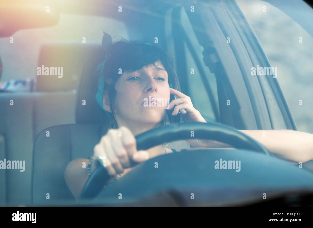Pretty woman driving the car and talking on phone Stock Photo - Alamy