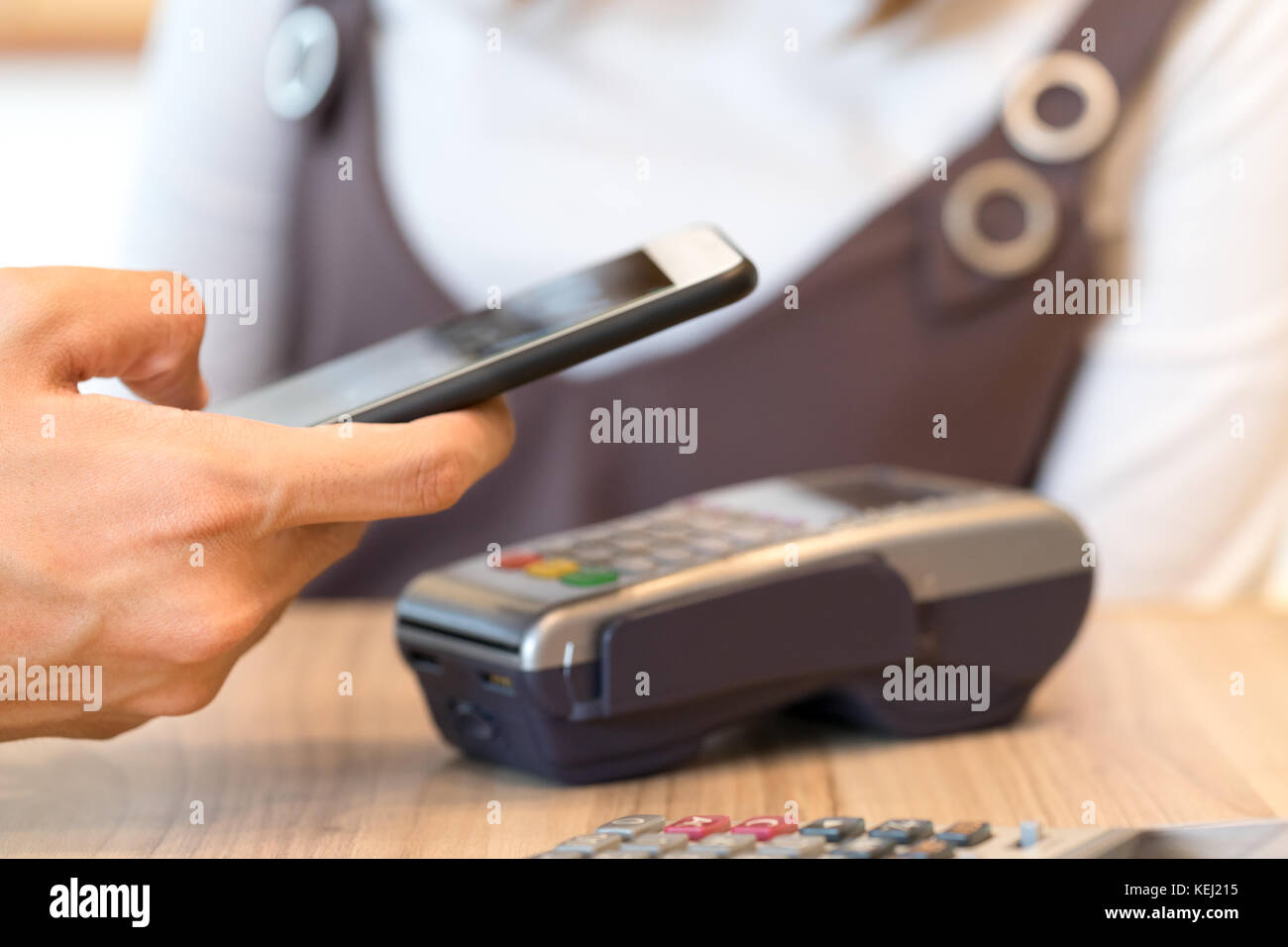 Man paying money via smartphone with magnetic card concept - financial ...