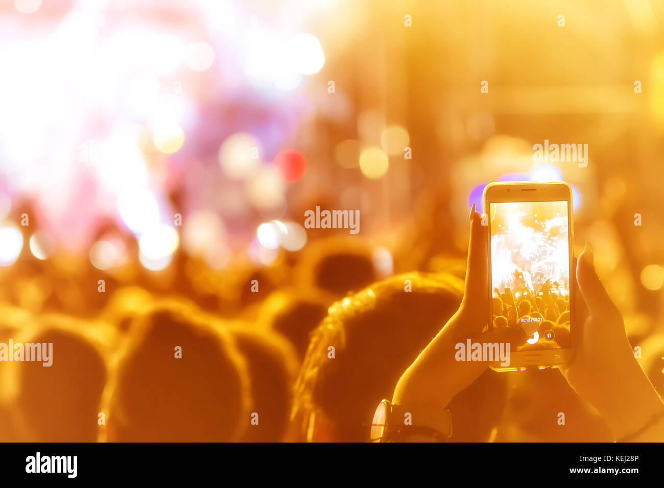 Hand with a smartphone records live music festival, Taking photo of ...