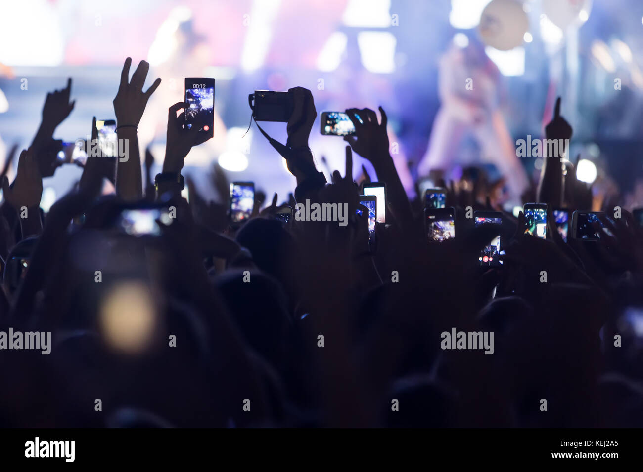 Hand with a smartphone records live music festival, Taking photo of ...