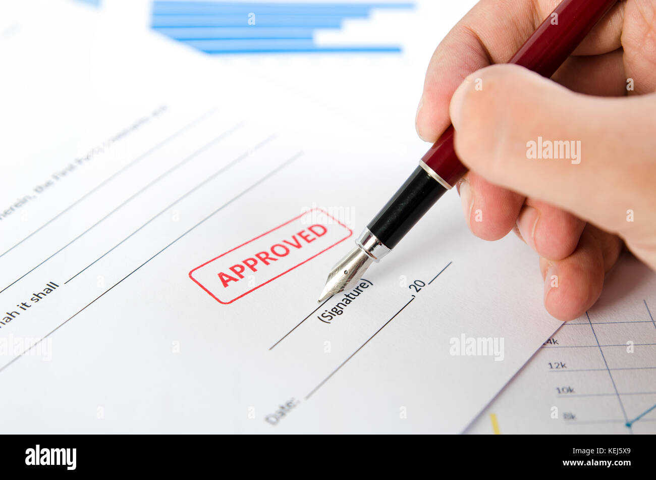 Man signs the contract with pen. Approved stamp on document. stamp ...