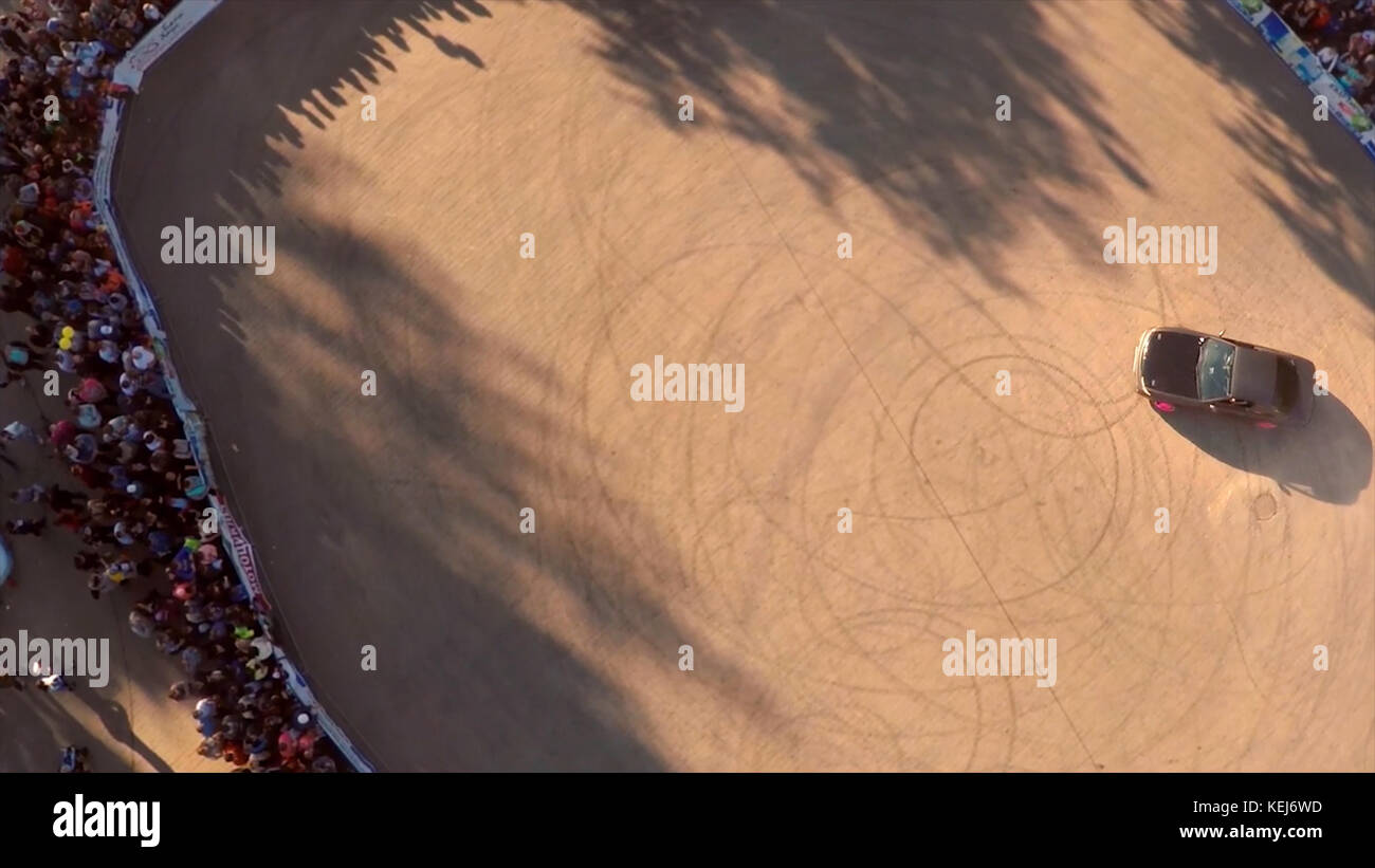 Top view aerial from flying drone of a professional driver drifting car ...