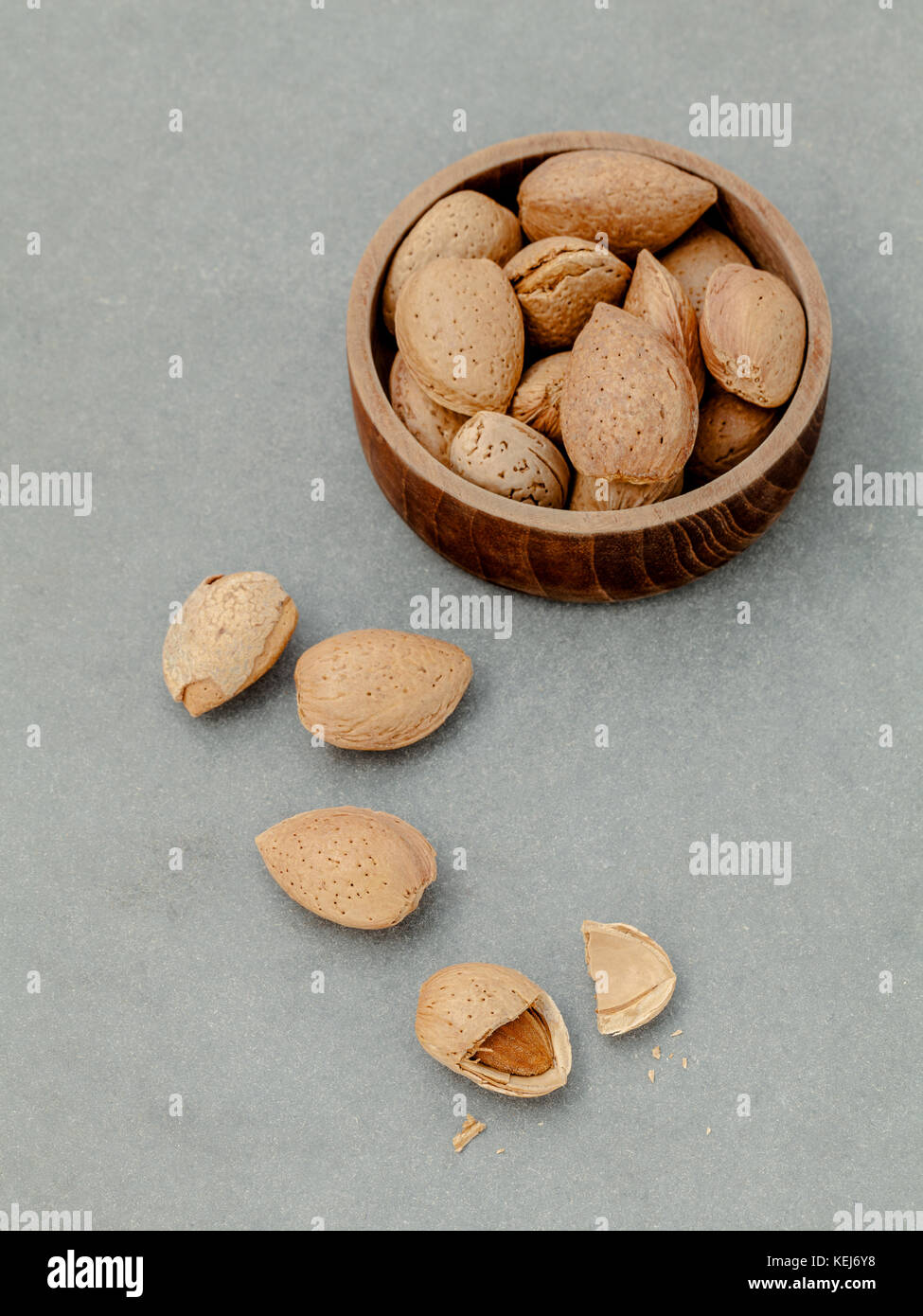 Almonds kernels and whole almonds on concrete background. Whole and ...