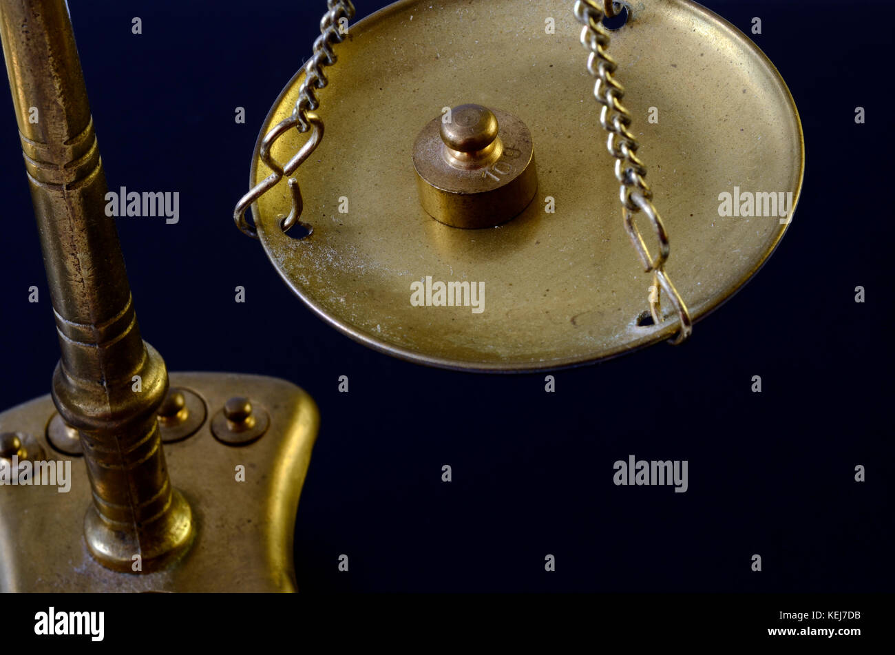 Golden weighing scale and weights on black background Stock Photo - Alamy